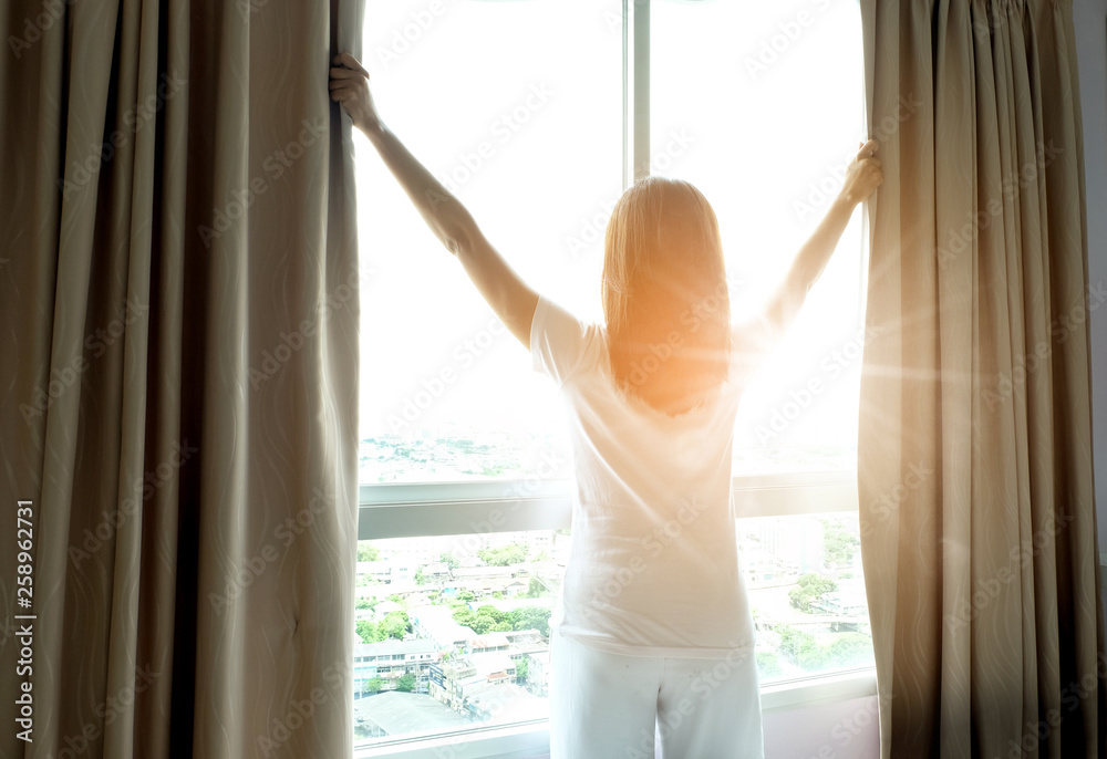 Morning of a new day, wake up woman stand up in the room refreshing and ...