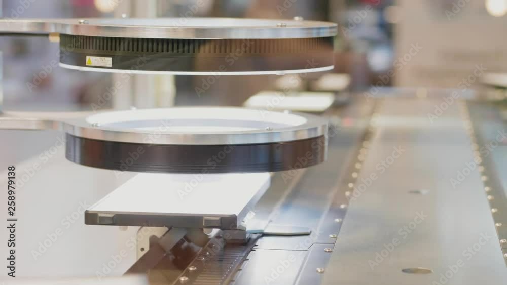 Lens of automatic test set scanning details on high speed conveyor belt ...