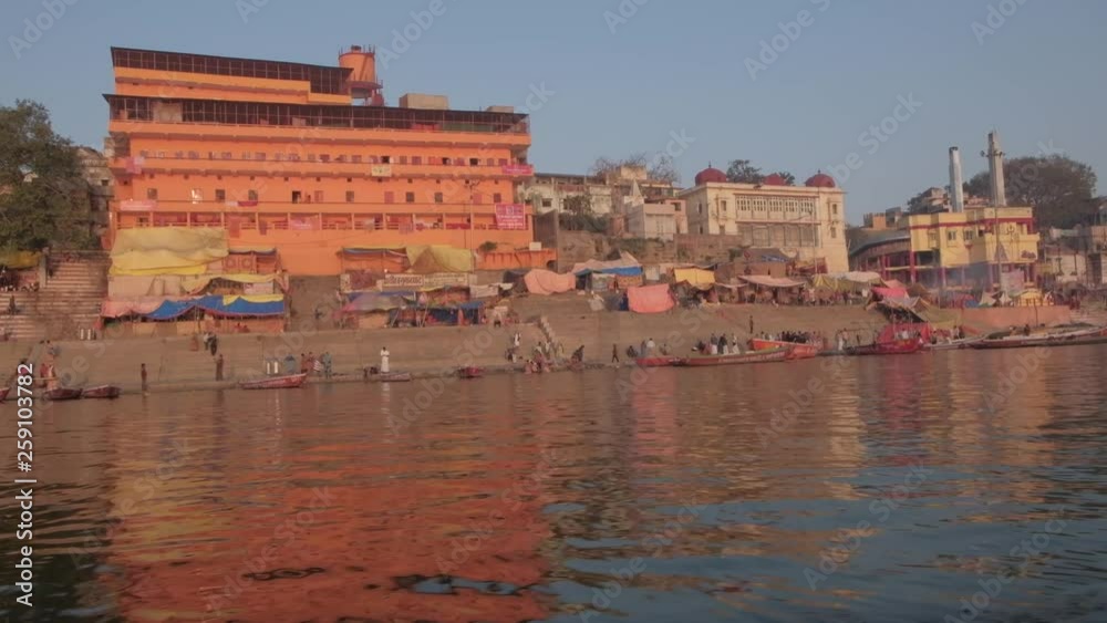 View of buildings of temples with ancient architecture and ghats of ...