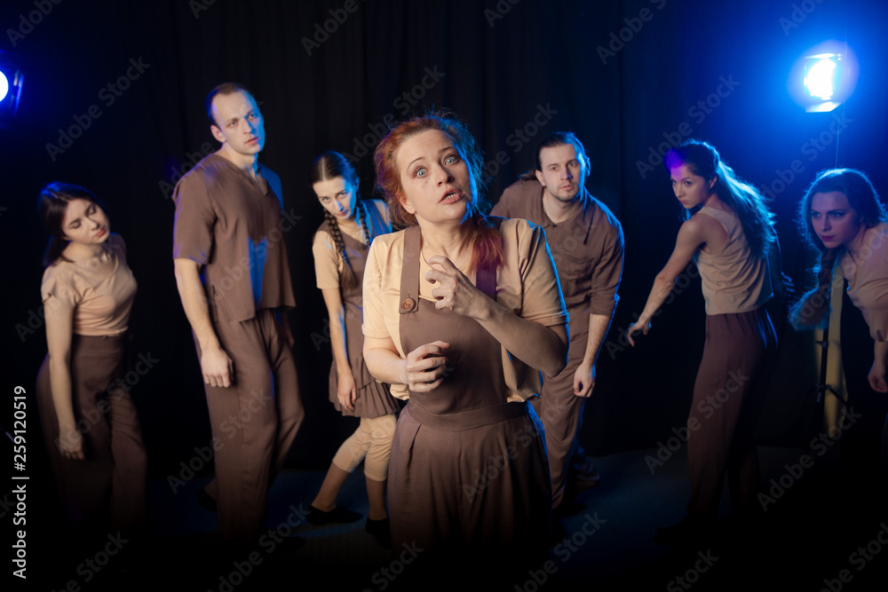 The actors on the stage play an emotion performance on a black ...