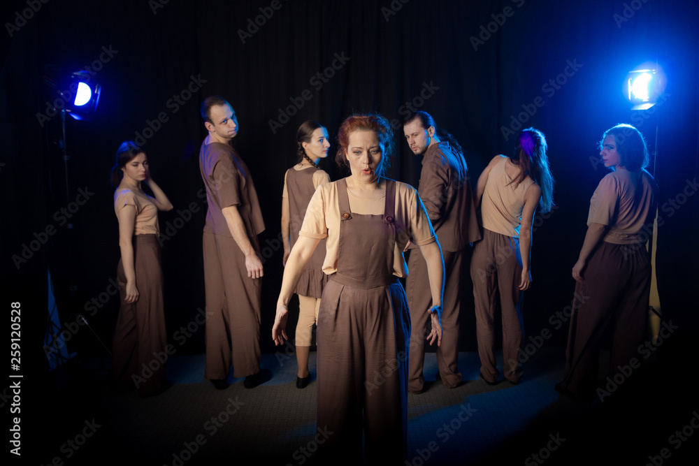The actors on the stage play an emotion performance on a black ...