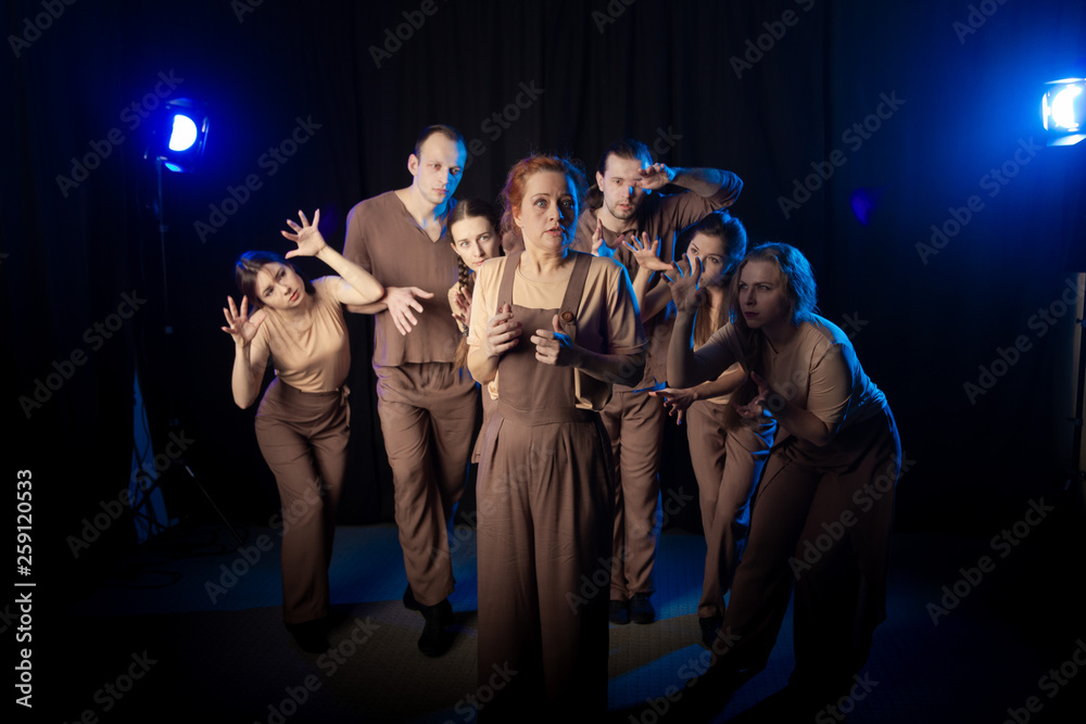 The actors on the stage play an emotion performance on a black ...