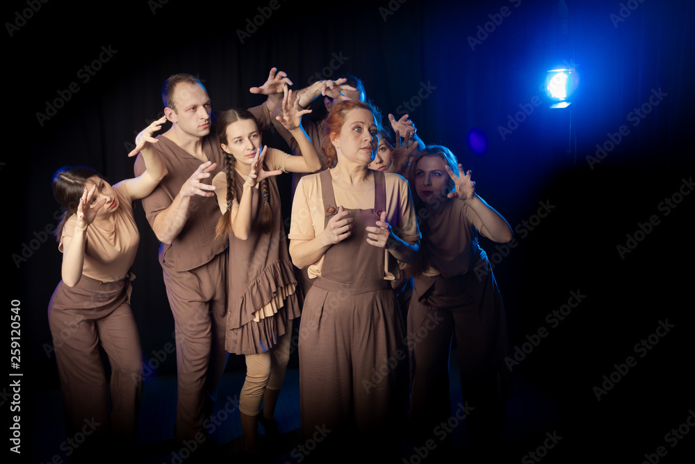 The actors on the stage play an emotion performance on a black ...