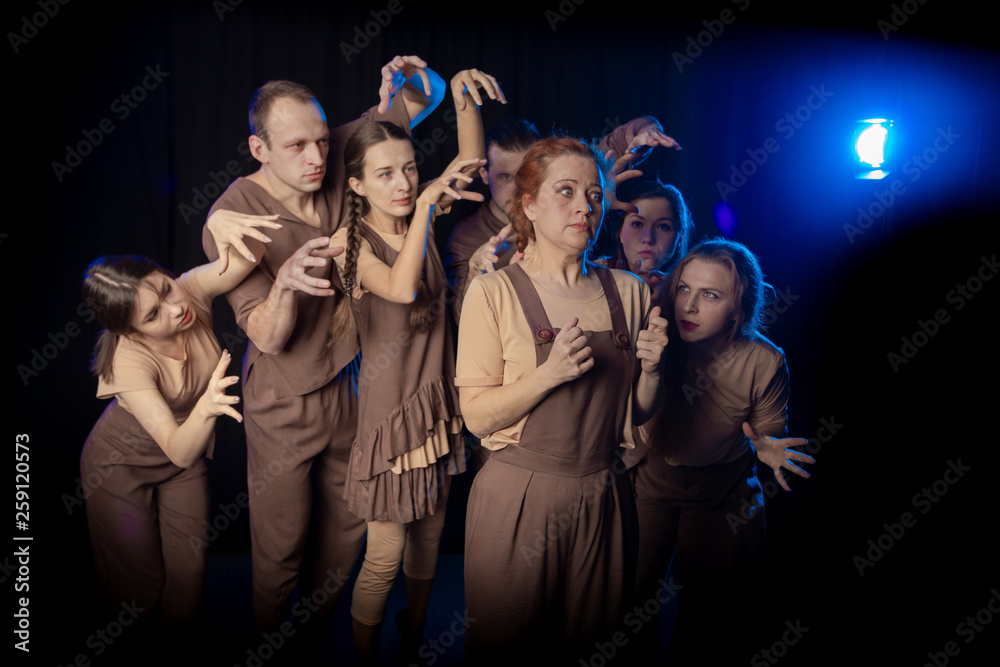 The actors on the stage play an emotion performance on a black ...