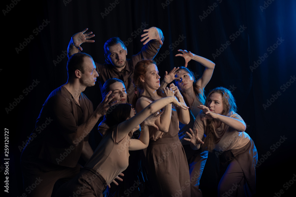 The actors on the stage play an emotion performance on a black ...