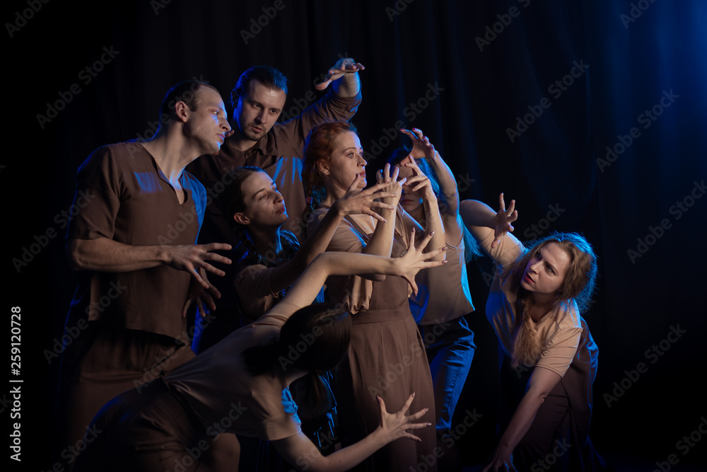The actors on the stage play an emotion performance on a black ...