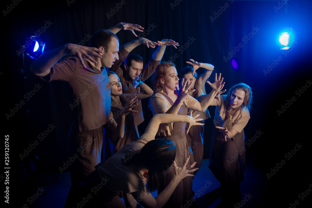 The actors on the stage play an emotion performance on a black ...