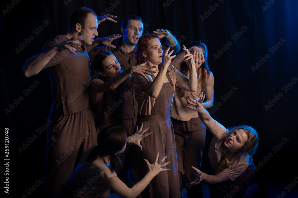 The actors on the stage play an emotion performance on a black ...