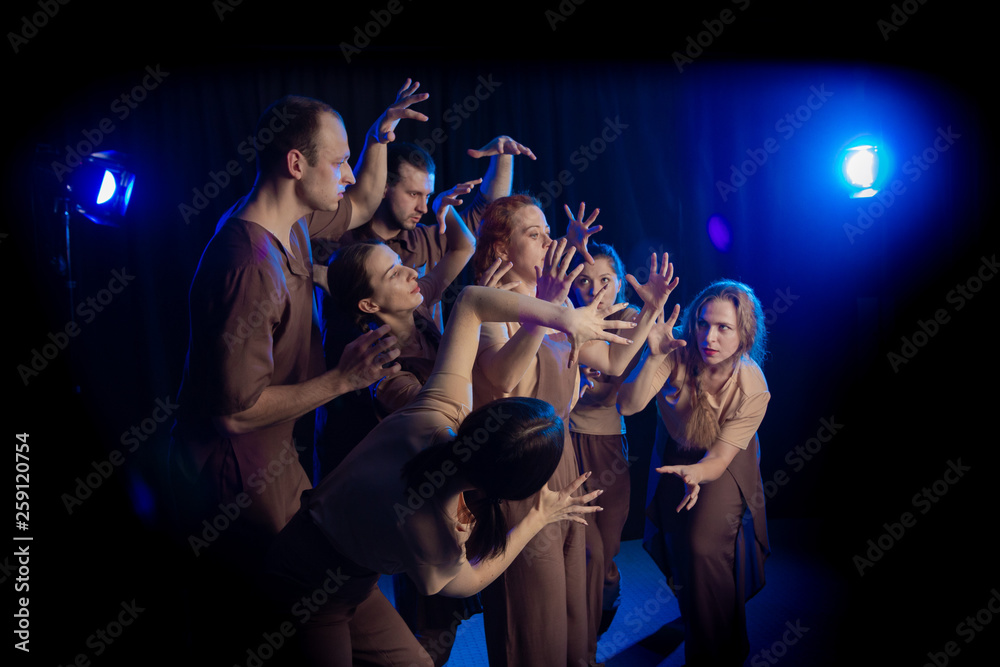 The actors on the stage play an emotion performance on a black ...