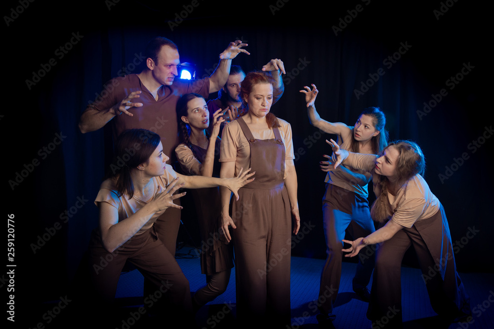 The actors on the stage play an emotion performance on a black ...