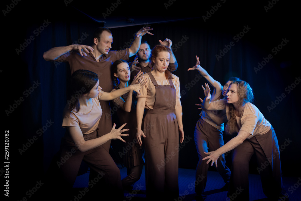 The actors on the stage play an emotion performance on a black ...