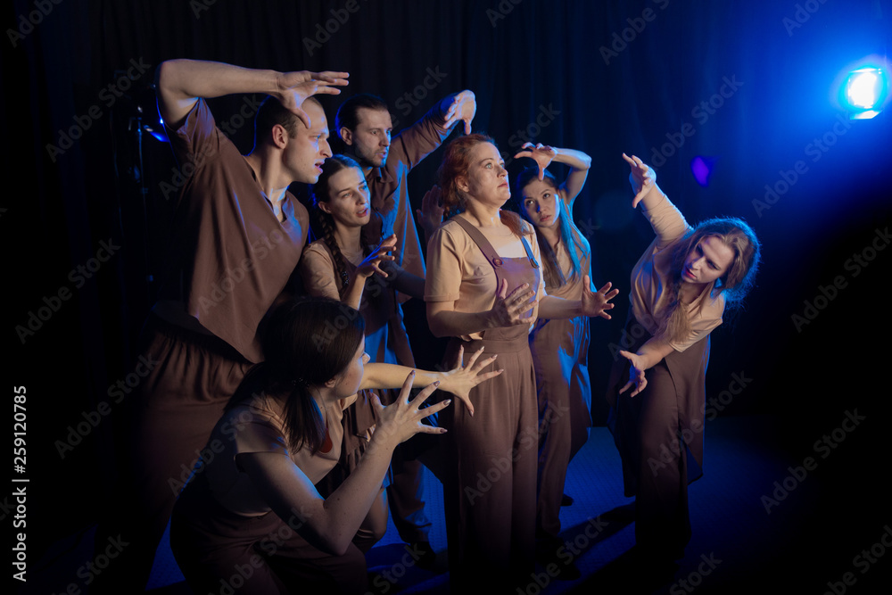 The actors on the stage play an emotion performance on a black ...