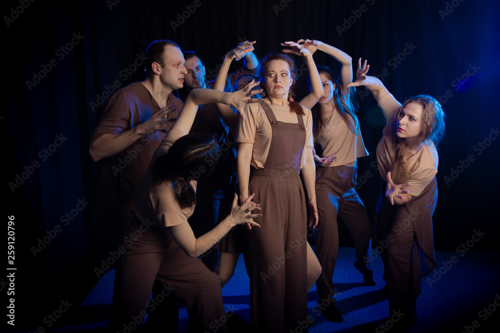 The actors on the stage play an emotion performance on a black ...