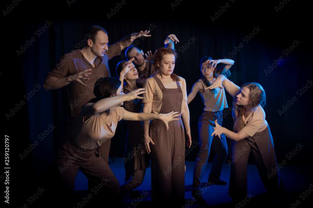 The actors on the stage play an emotion performance on a black ...