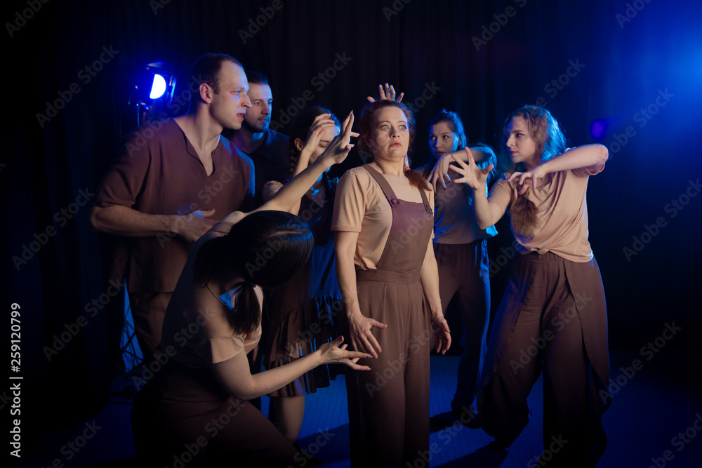 The actors on the stage play an emotion performance on a black ...