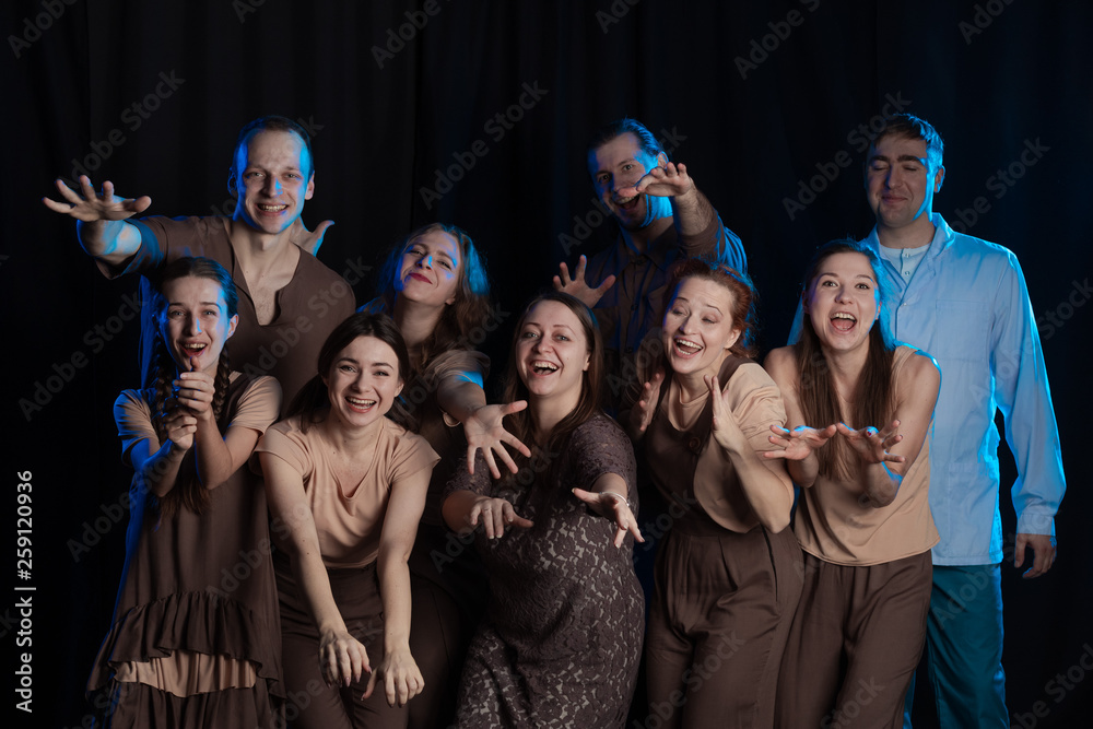 The actors on the stage play an emotion performance on a black ...
