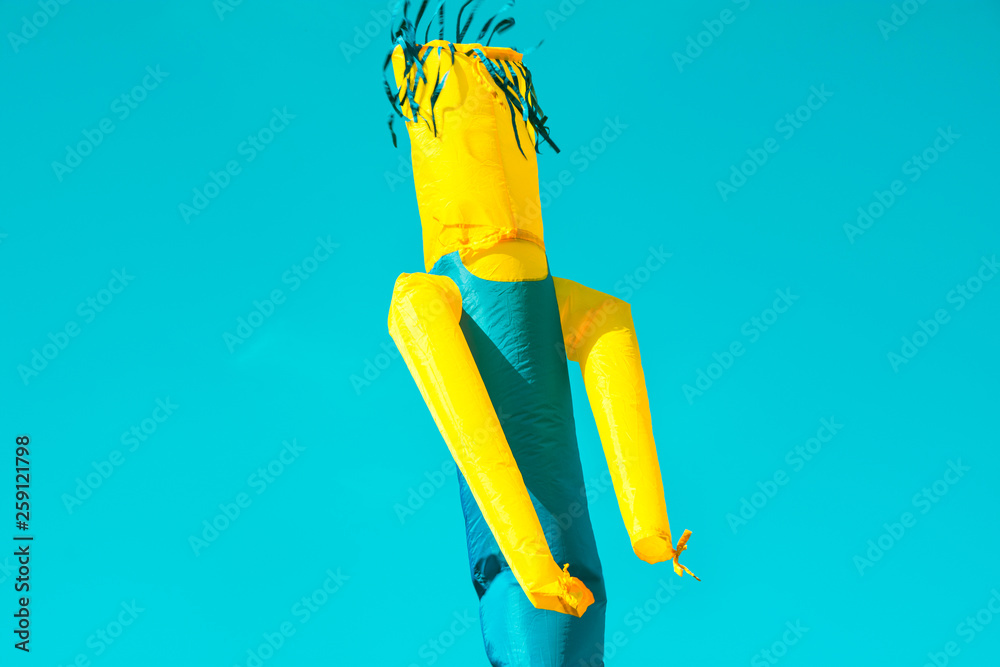 Huge figure of inflatable turquoise and yellow tube man skydancer ...