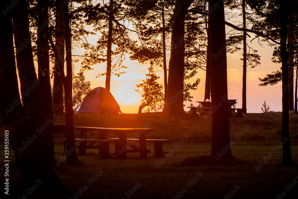 Camping on the beach during the sunset or sunrise. Bright sunlight ...