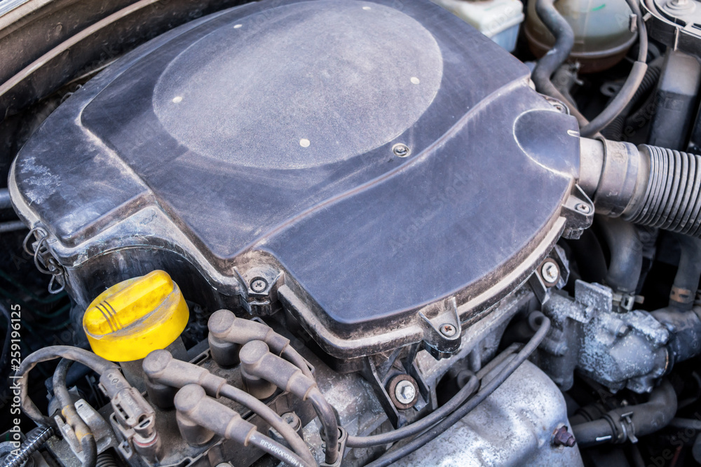 Close up view of an used and dirty car engine. Old auto parts under the ...