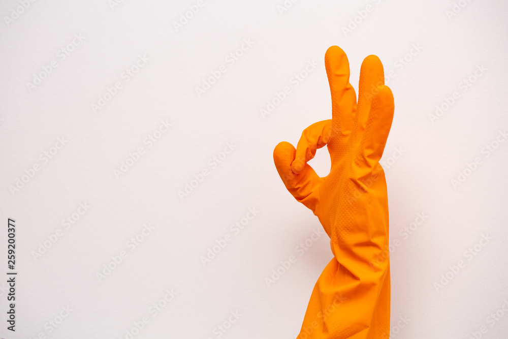 Ok sign of orange rubber gloves. Preparing for cleaning. Hands clean ...