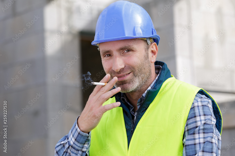 smoking cigarette on construction site Stock Photo | Adobe Stock