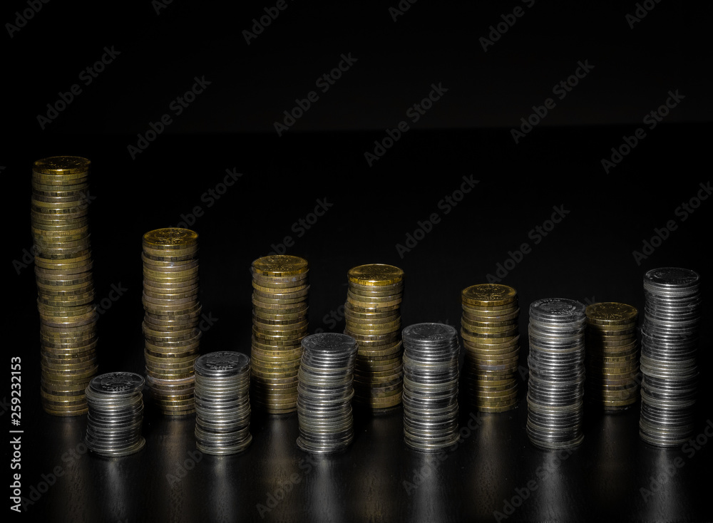 Ascending and descending trends. Two rows of coin stacks. Silver and ...