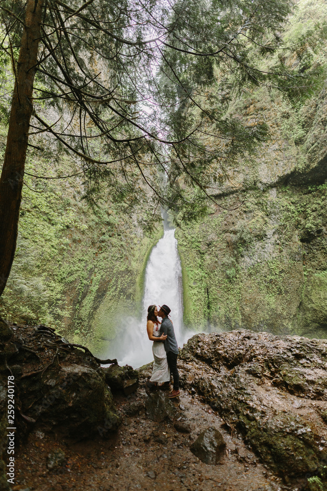 Beautiful Couple Kissing In Front Of Waterfall Stock Photo | Adobe Stock