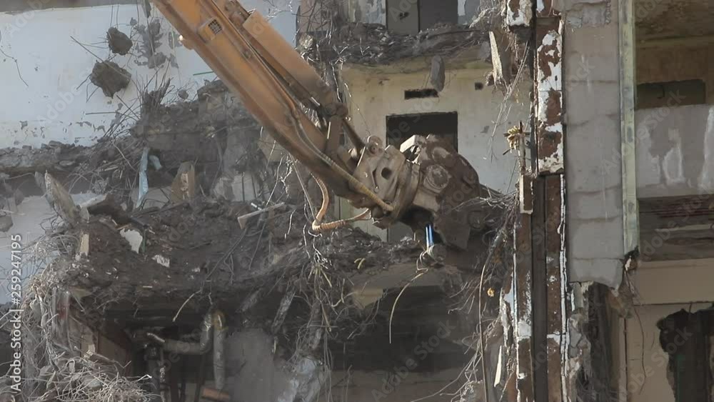 Demolition of building. Grab crane with hydraulic scissors closeup ...