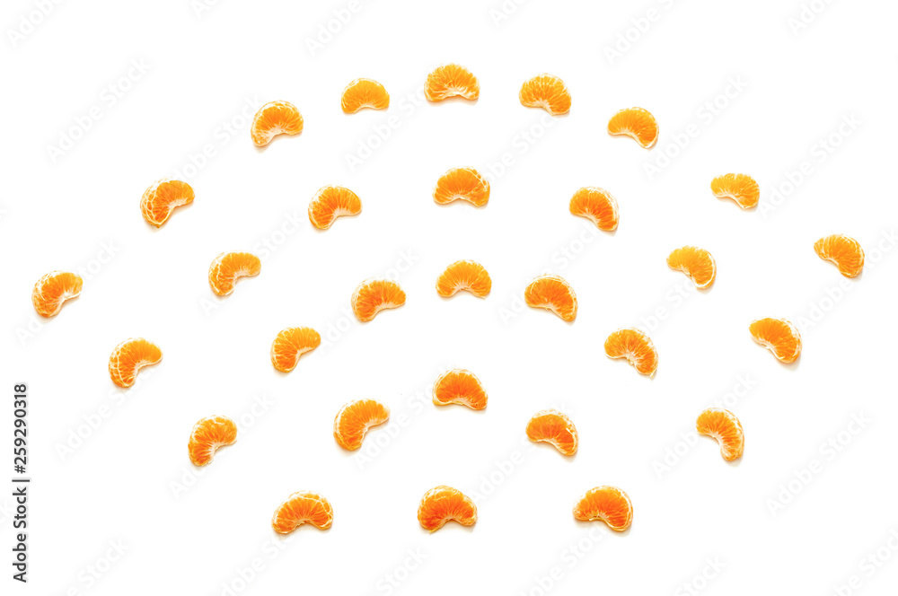 peeled tangerine slices on a white background are laid out in the form ...