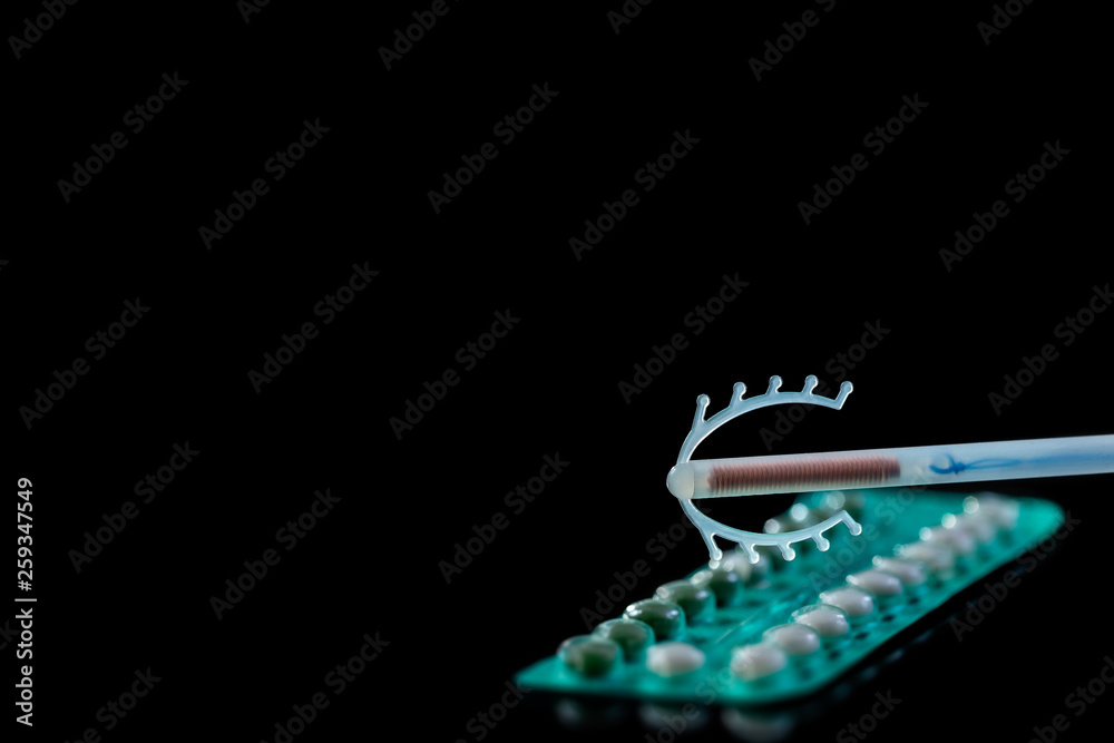 Birth Control symbole- IUD and contraceptive Pills on on black ...