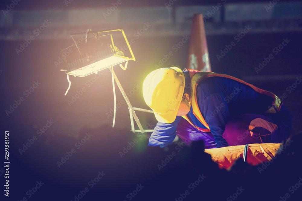 selective focus to spotlight and construction worker is working at ...