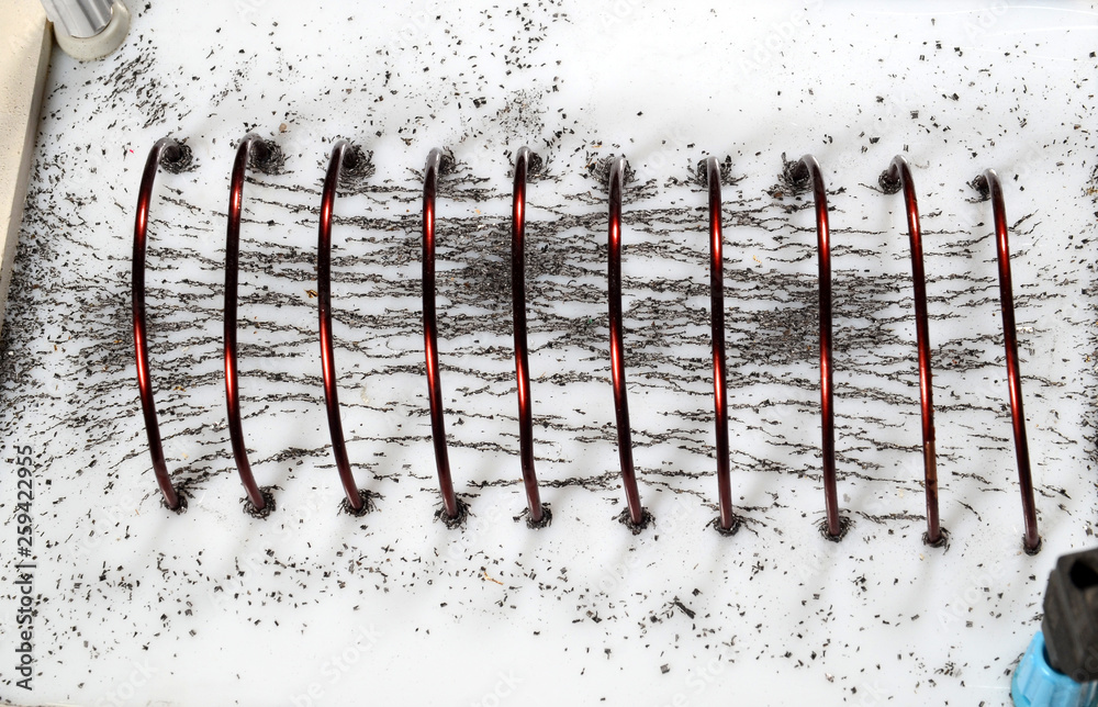 Iron powder shows the magnetic lines of forces in a coil, where a ...