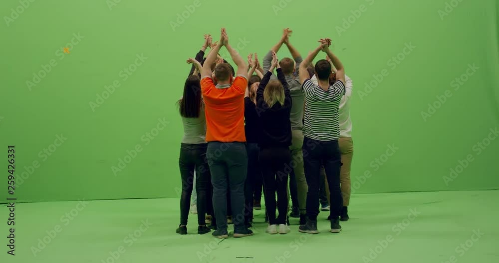 GREEN SCREEN CHROMA KEY Back view group of young people standing and ...