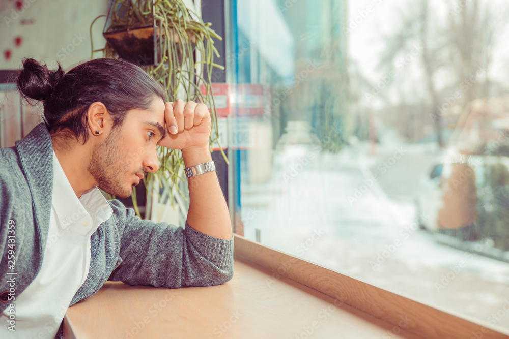 Sad young man looking down upset, hand on forehead. Stock Photo | Adobe ...