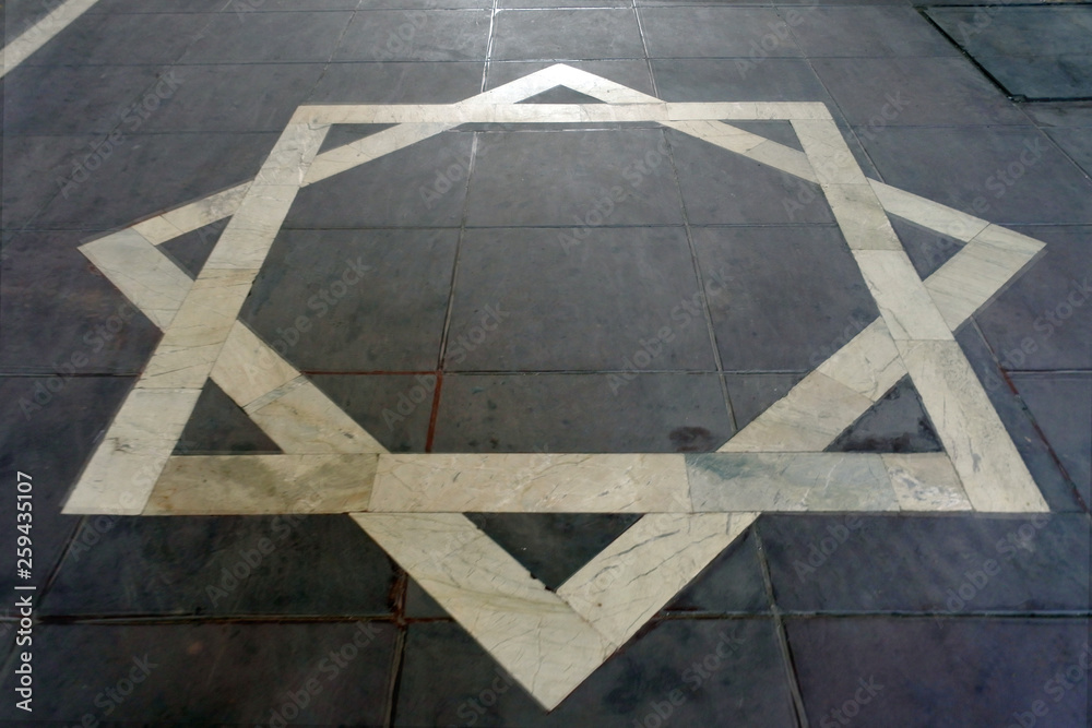 Stone floor with octagram.The Star of Lakshmi. Octagram of two squares ...