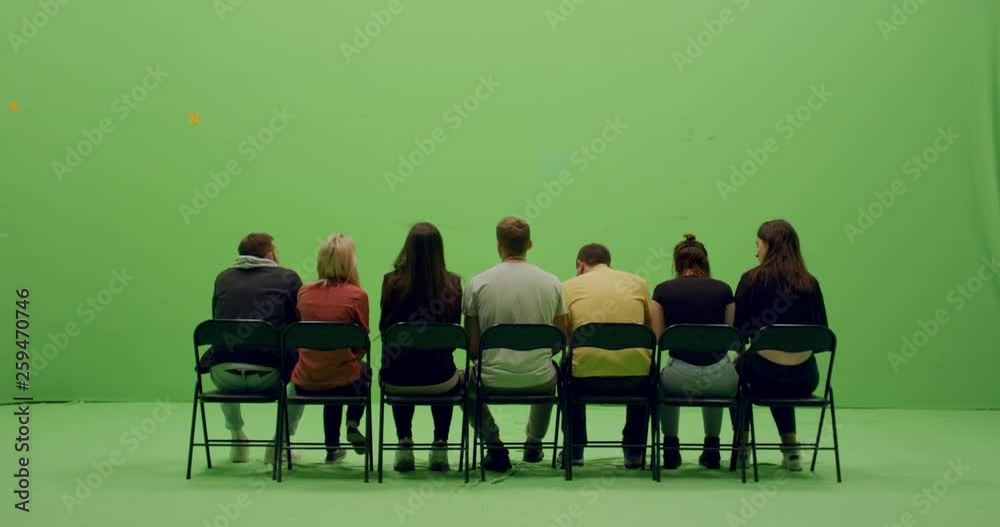GREEN SCREEN CHROMA KEY Back view group of young people watching and ...
