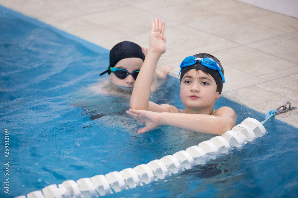 boys swimming in pool Stock Photo | Adobe Stock