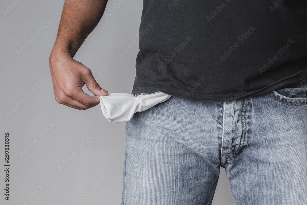 Poor man concept with adult caucausian male showing his empty pockets ...