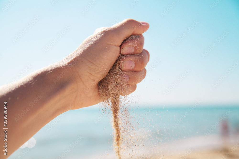 Sand in hand. Sea background. Stock Photo | Adobe Stock