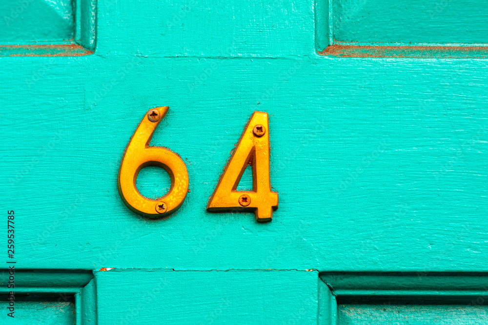 House number 64 with the sixty-four in bronze metal on the middle cross ...