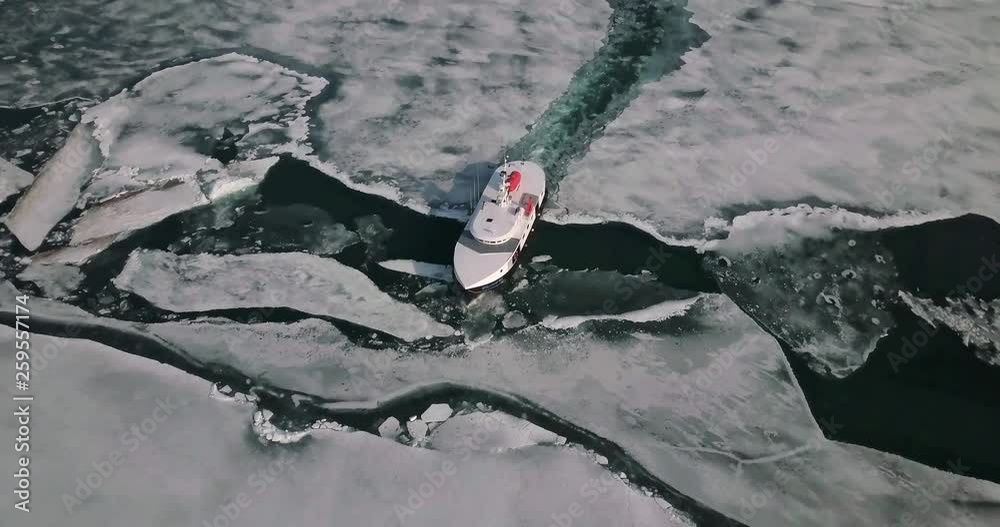 An icebreaker ship creating a path into the frozen Lake Erie (one of ...