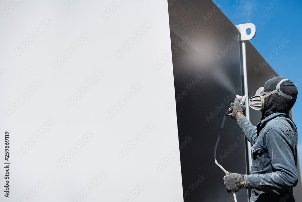 Airless Spray Painting, Worker painting on steel wall surface by ...