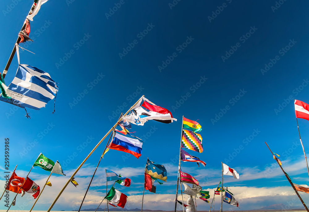 Multiple country flags against the wind at Plaza de las Banderas Uyuni ...