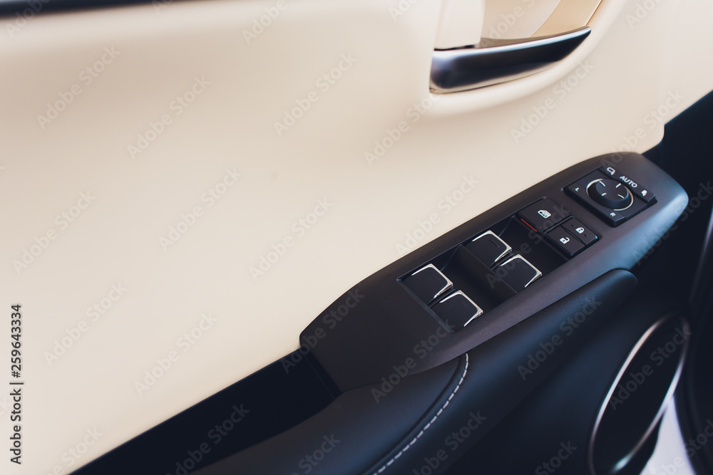 car leather interior details of door handle with windows controls and ...