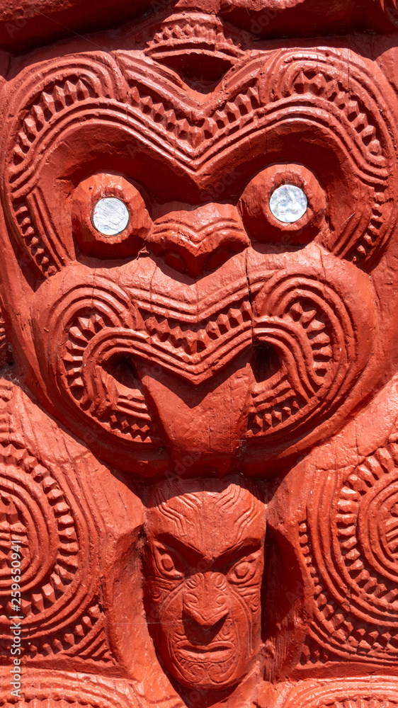 Traditional Maori tekoteko wood carving of face with paua shell ...