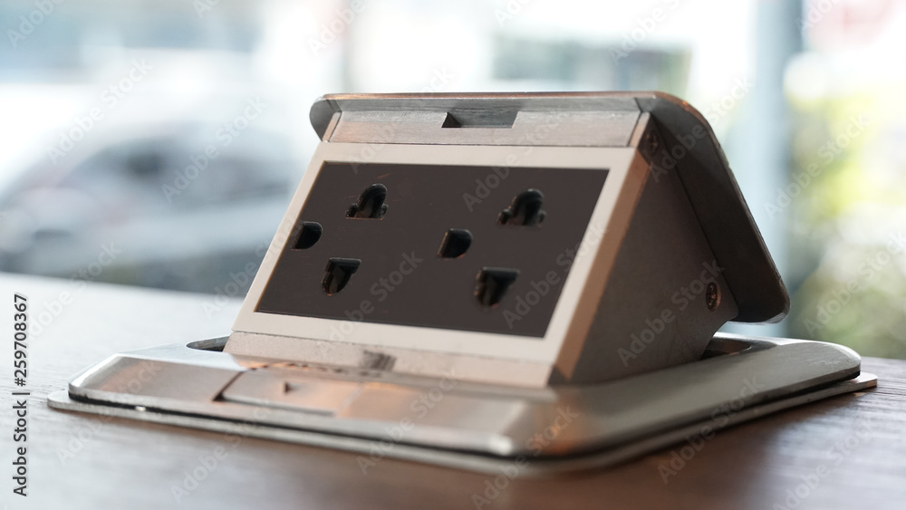 Electrical outlet with dual 3 pin on wood table in coffee shop. Stock ...