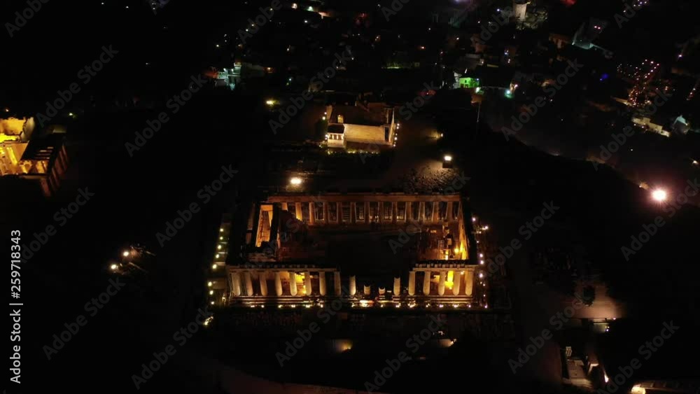 Aerial drone night video of iconic illuminated landmark Acropolis hill and the Masterpiece of ...