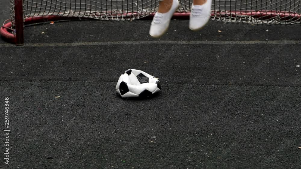 Vidéo Stock Angered woman crush and jump on deflated soccer ball, then ...