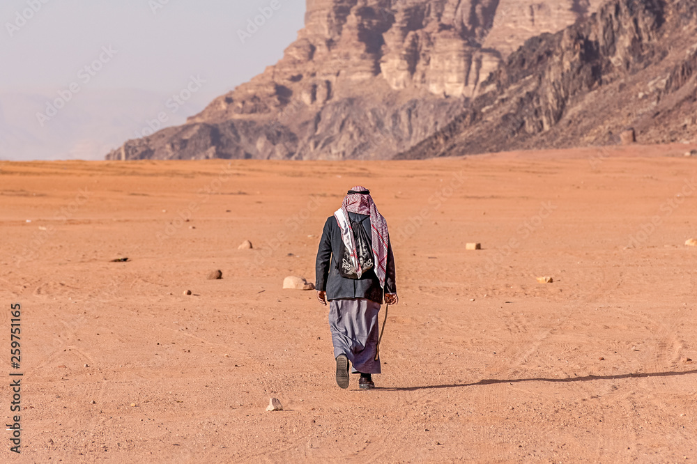 .25/02/2019 WadiRum, Jordan, Arab shepherd in shemag goes through ...