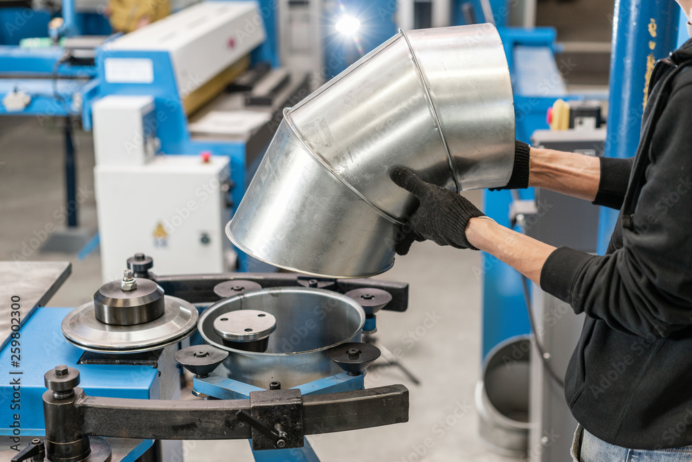 Worker controls the machine. Production rolling tool, electric machine ...
